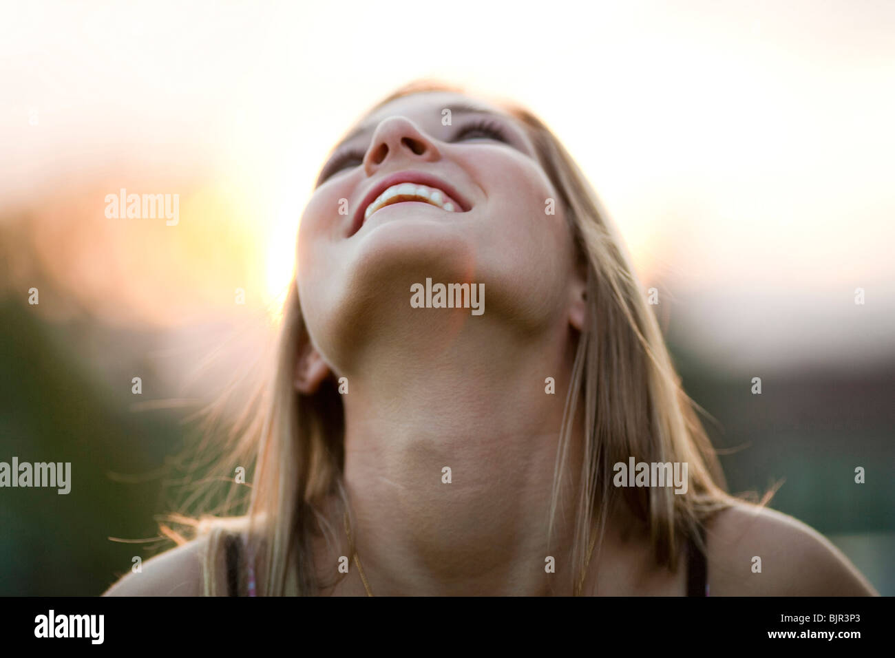 Teenage girl looking up smiling Stock Photo - Alamy
