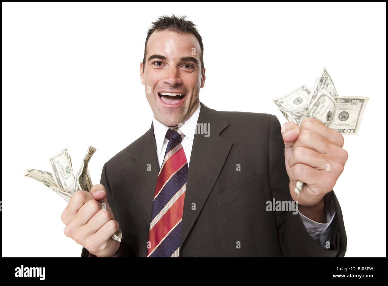 Businessman grasping money in both hands Stock Photo - Alamy