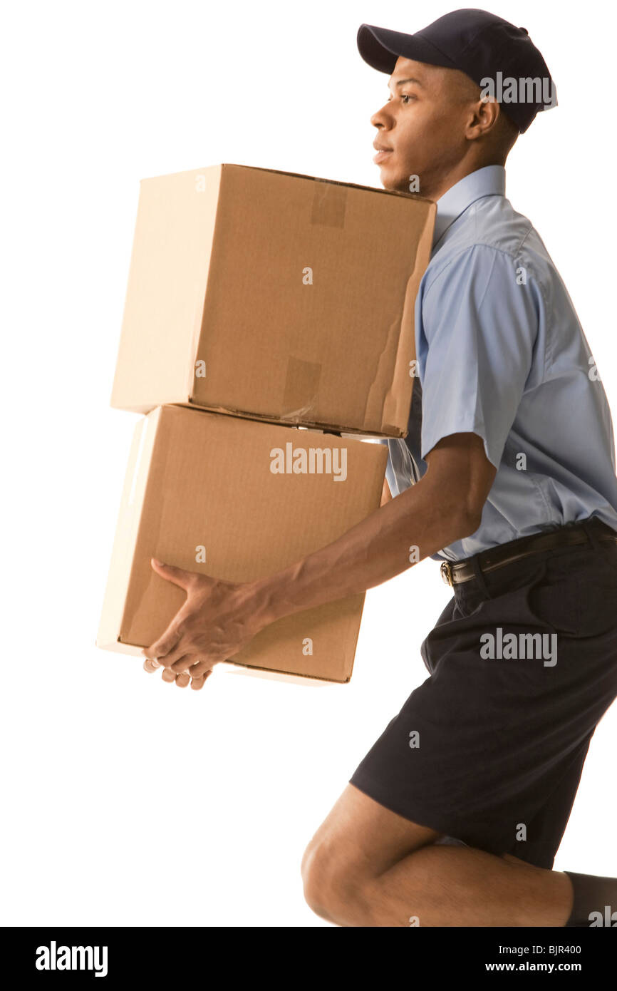 Deliveryman holding two parcels Stock Photo - Alamy