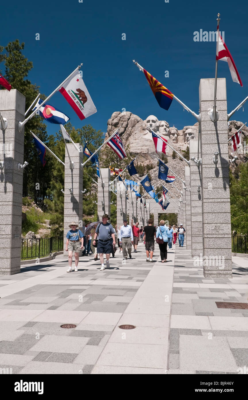 Tourists walking along the Avenue of Flags, Mount Rushmore National ...