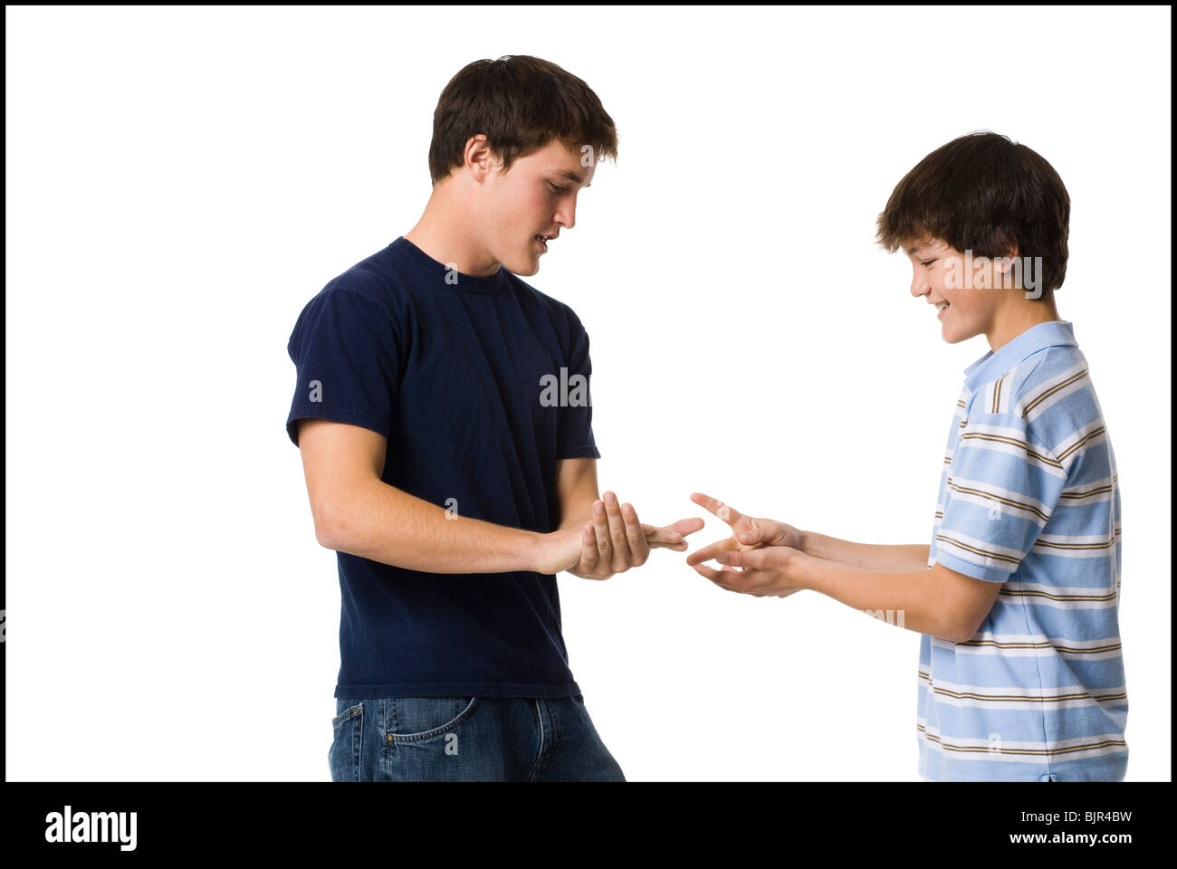 Two young men playing rock, paper, scissors Stock Photo - Alamy