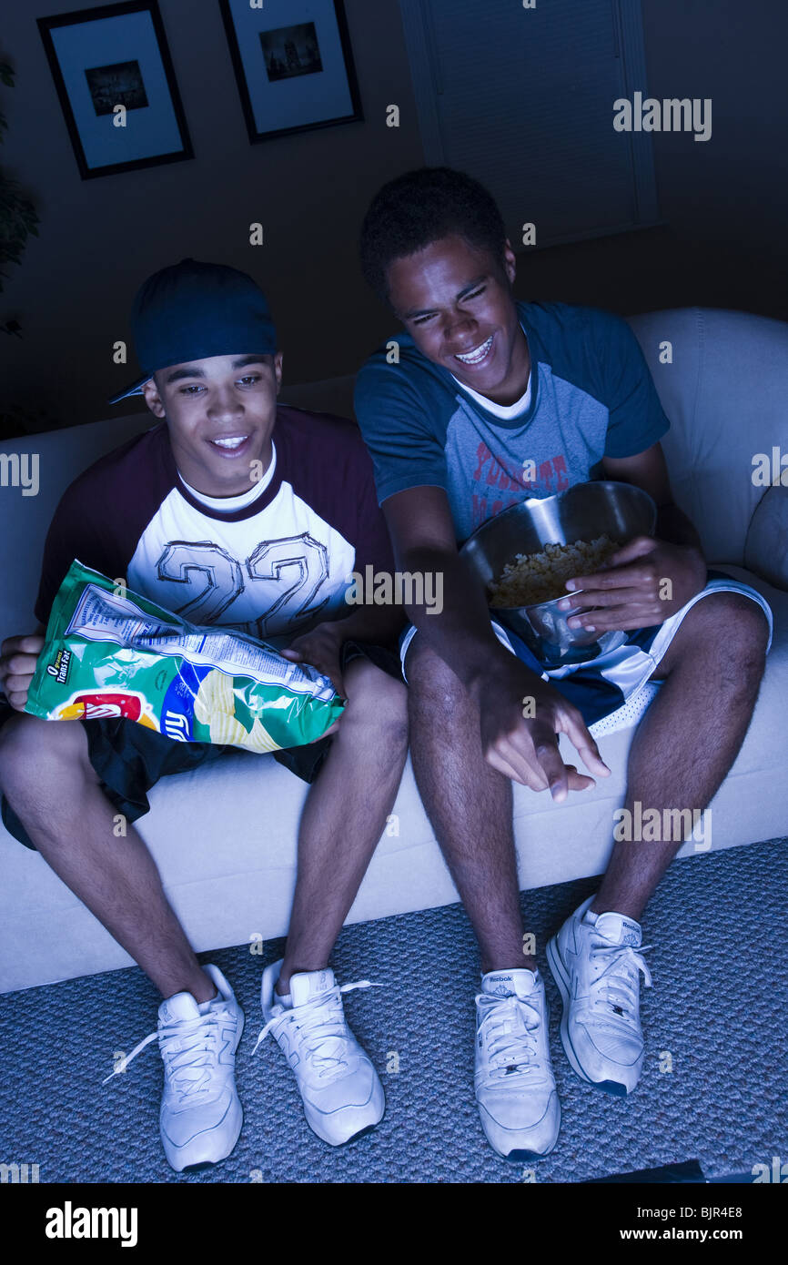 Two teenage boys eating snacks Stock Photo - Alamy