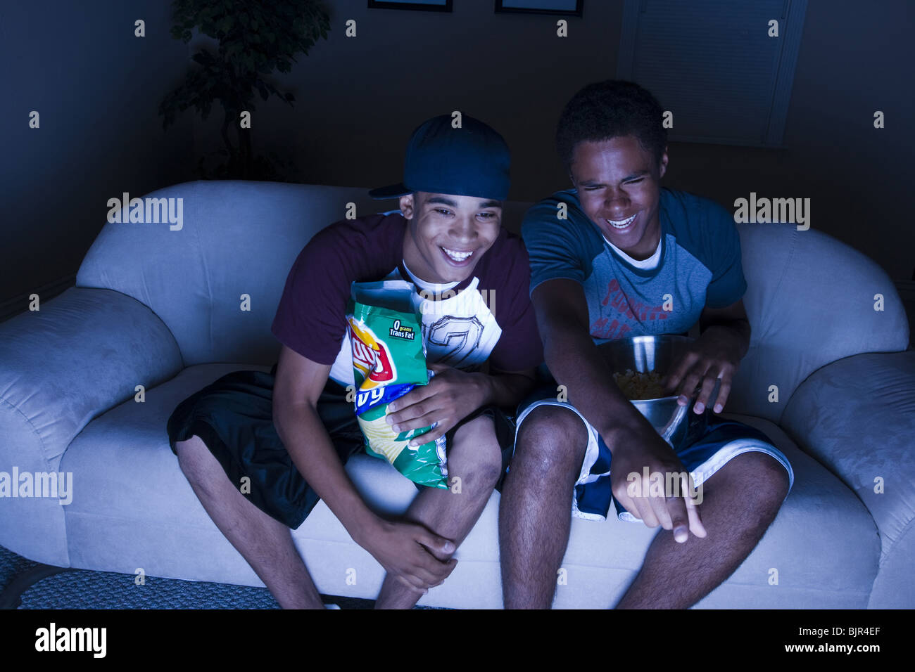 Two teenage boys eating snacks Stock Photo - Alamy