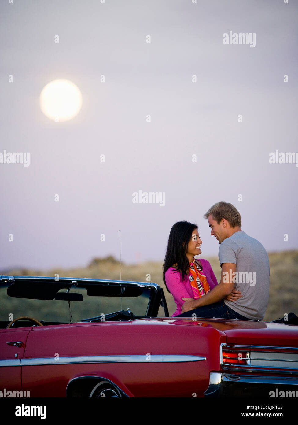 couple under a full moon Stock Photo - Alamy