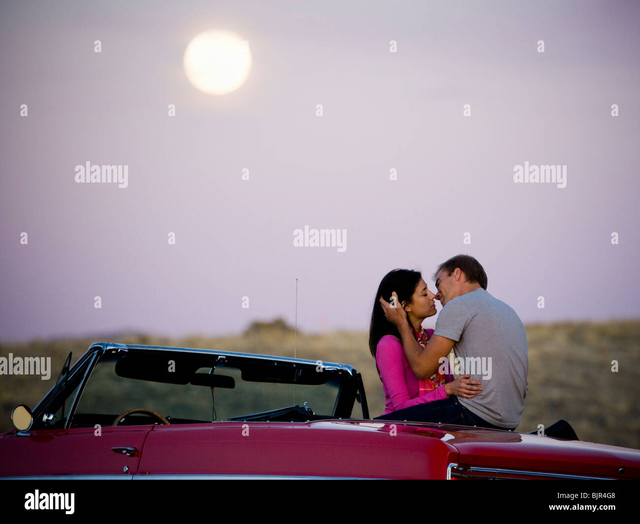 couple under a full moon Stock Photo - Alamy