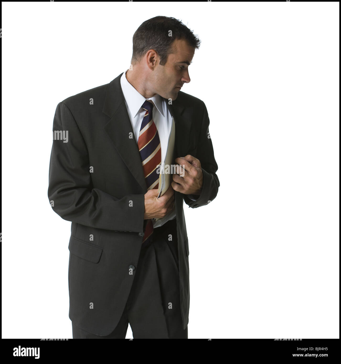 Businessman putting files into his jacket Stock Photo - Alamy