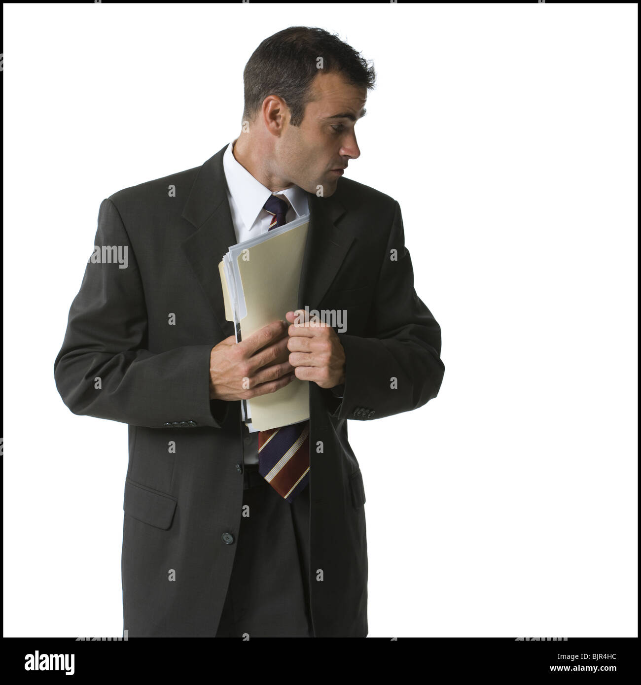 Businessman putting files into his jacket Stock Photo - Alamy
