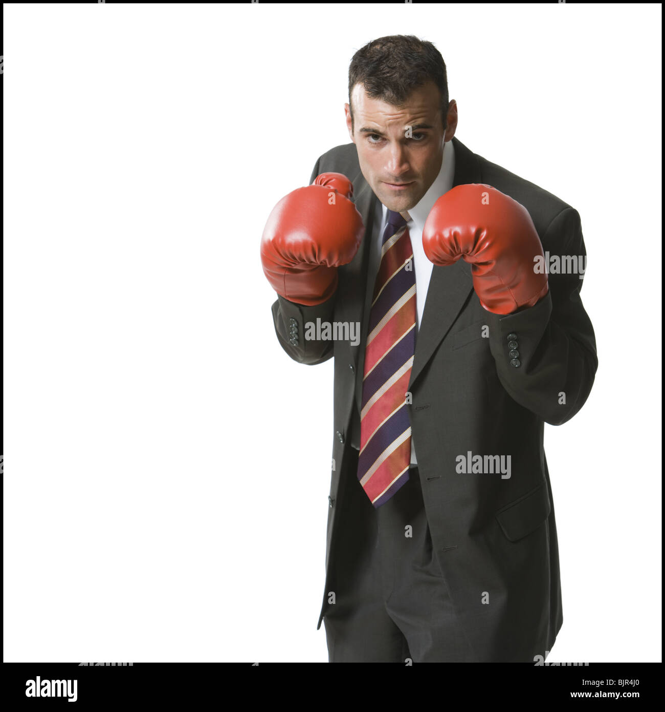 Businessman wearing boxing gloves Stock Photo - Alamy