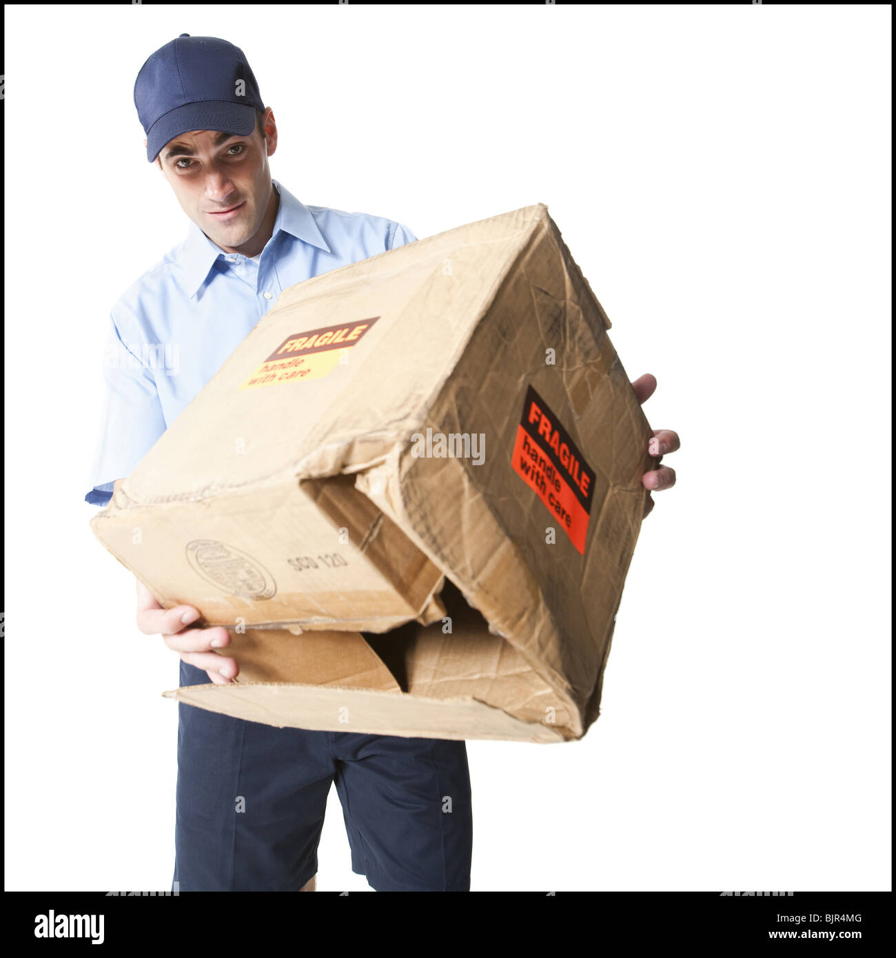 Deliveryman holding a damaged parcel Stock Photo - Alamy