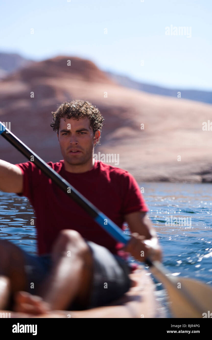 Man rowing in a boat Stock Photo - Alamy