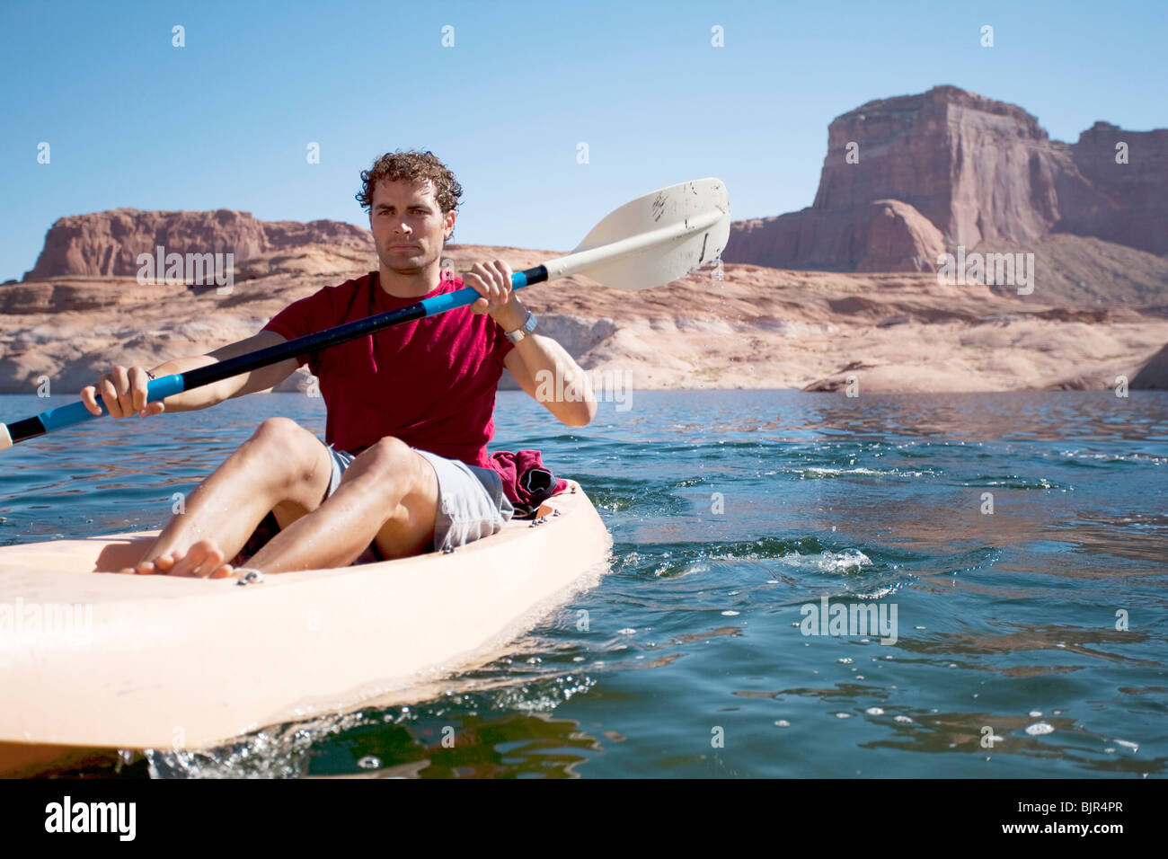 Man rowing in a boat Stock Photo - Alamy