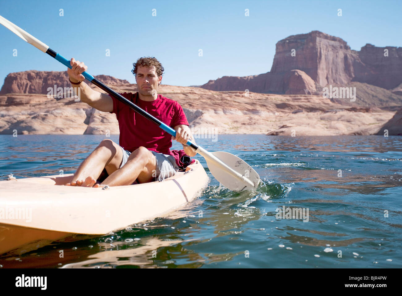Man rowing in a boat Stock Photo - Alamy