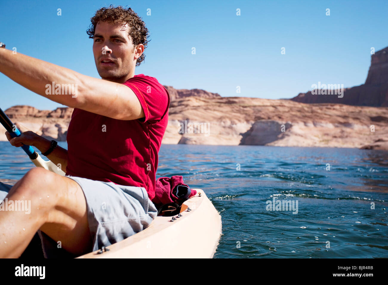 Man rowing in a boat Stock Photo - Alamy