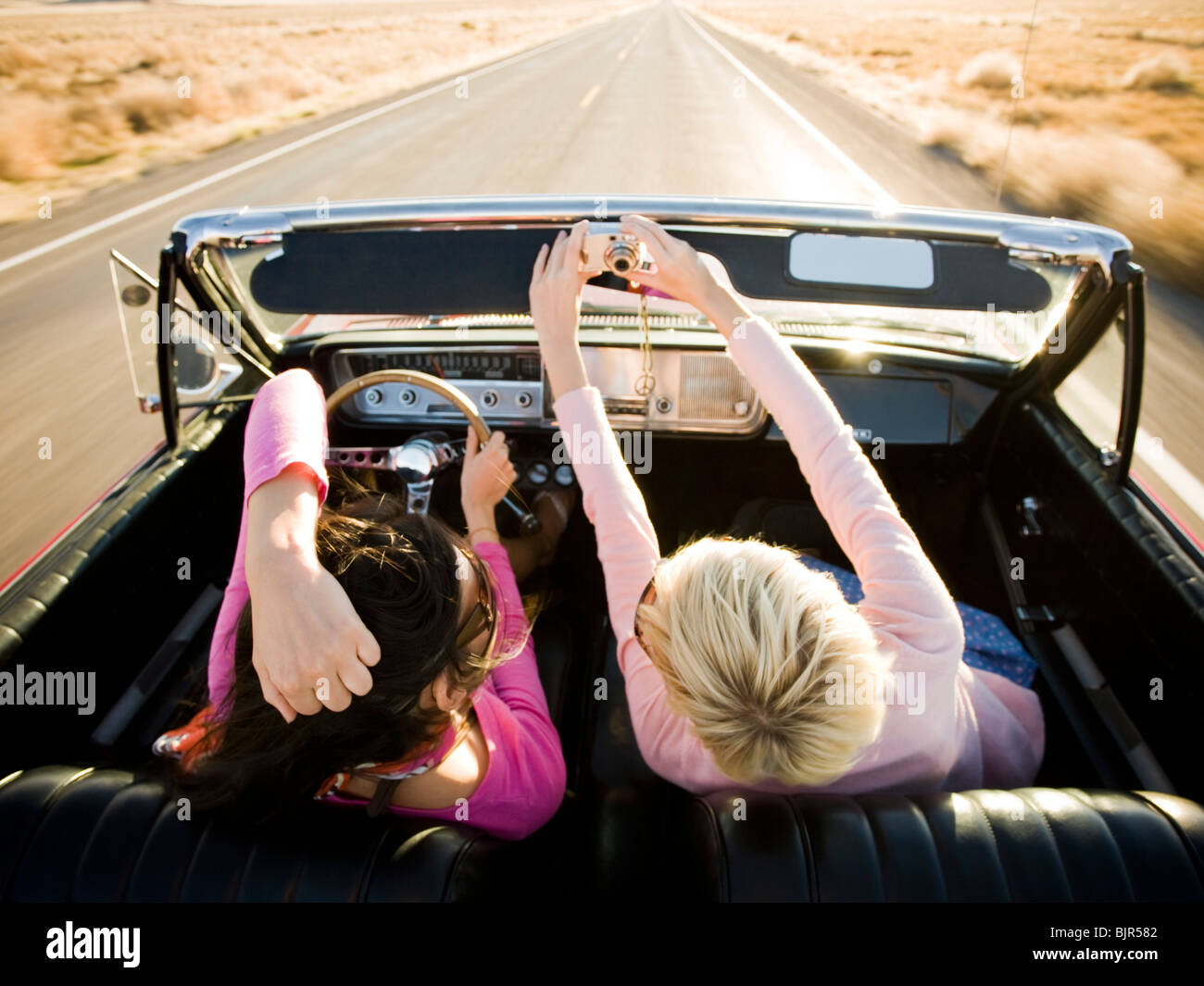 two women in a red convertible Stock Photo - Alamy