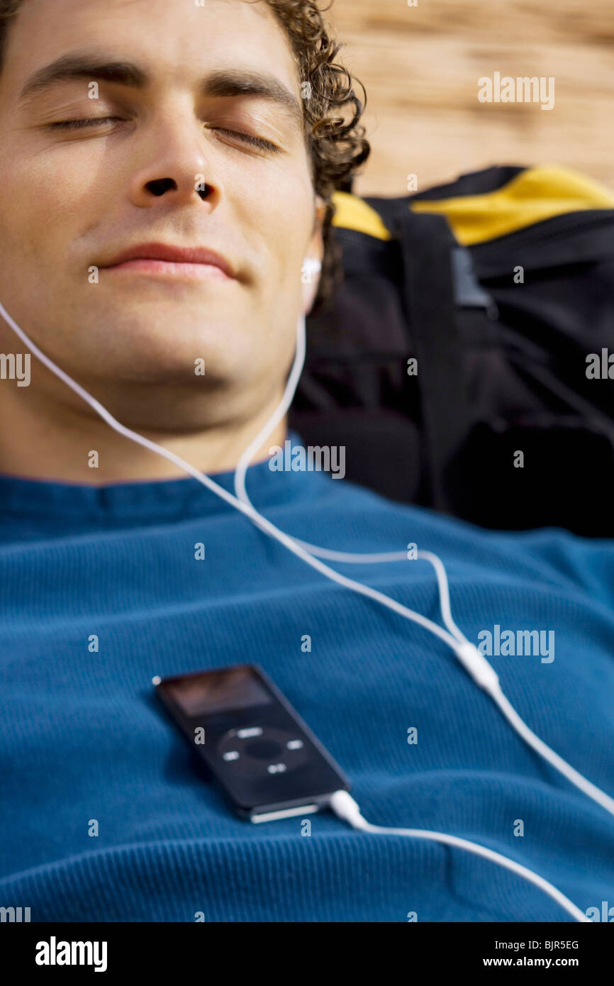 Man listening to MP3 player Stock Photo - Alamy