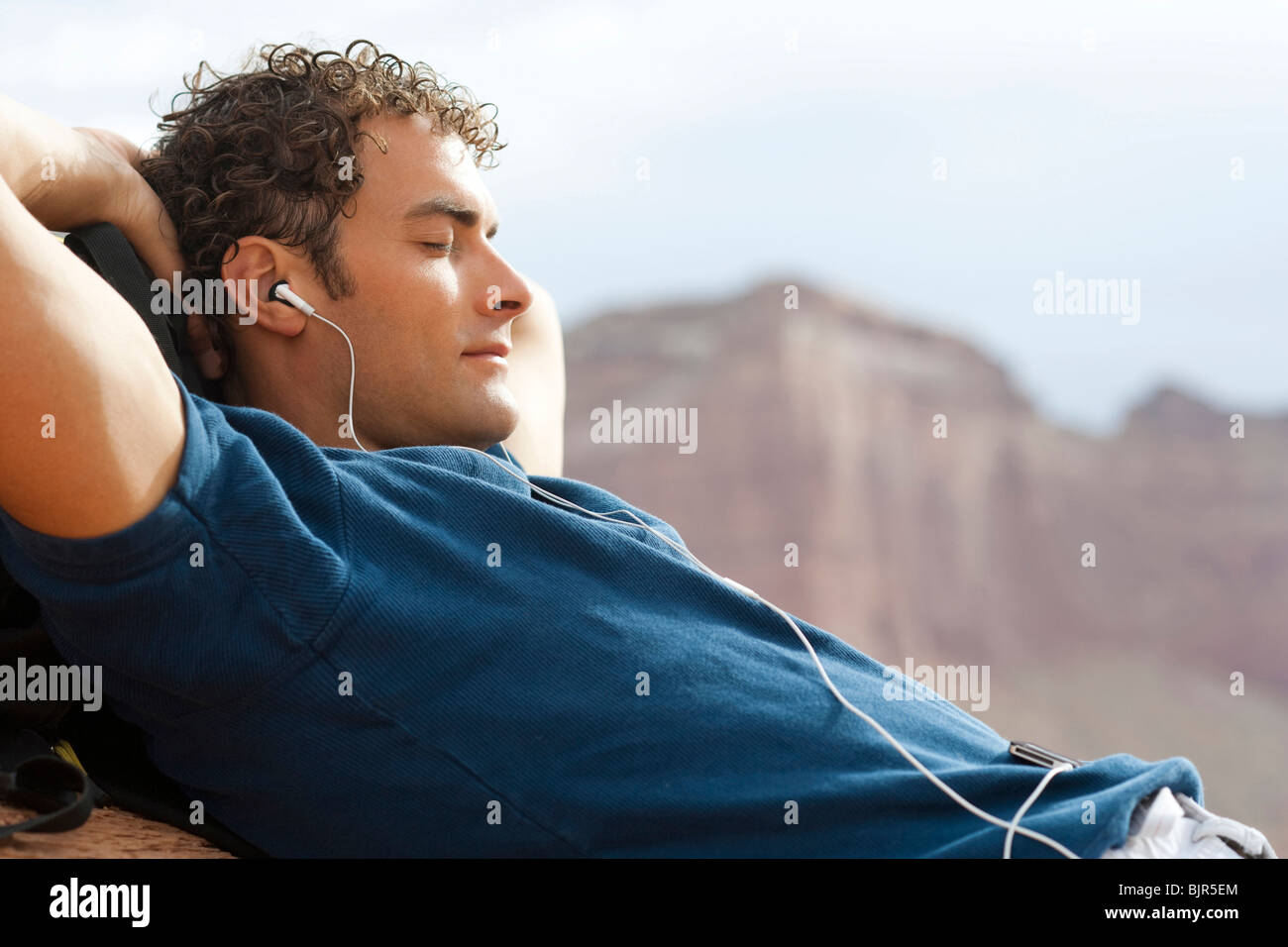 Man listening to MP3 player Stock Photo - Alamy