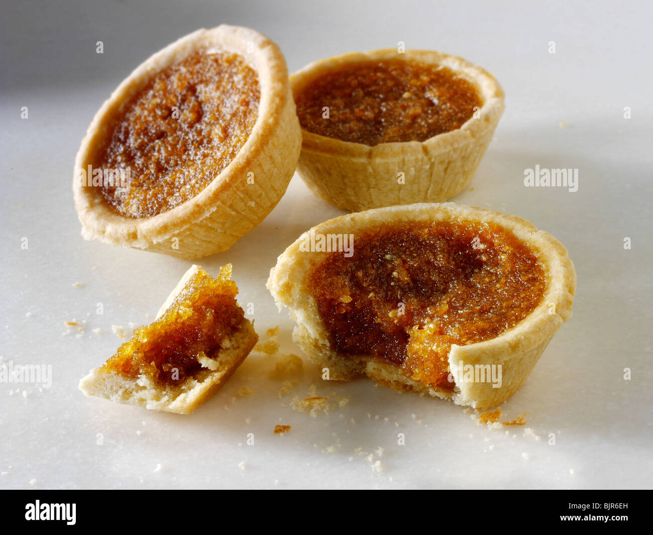 Individual traditional pastry treacle tarts on a white background Stock ...