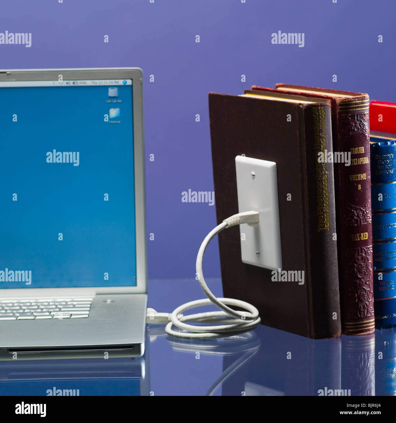 notebook computer plugged into books Stock Photo - Alamy