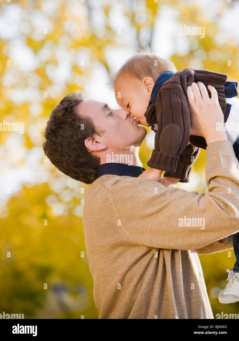 dad lifting baby boy in the air Stock Photo - Alamy
