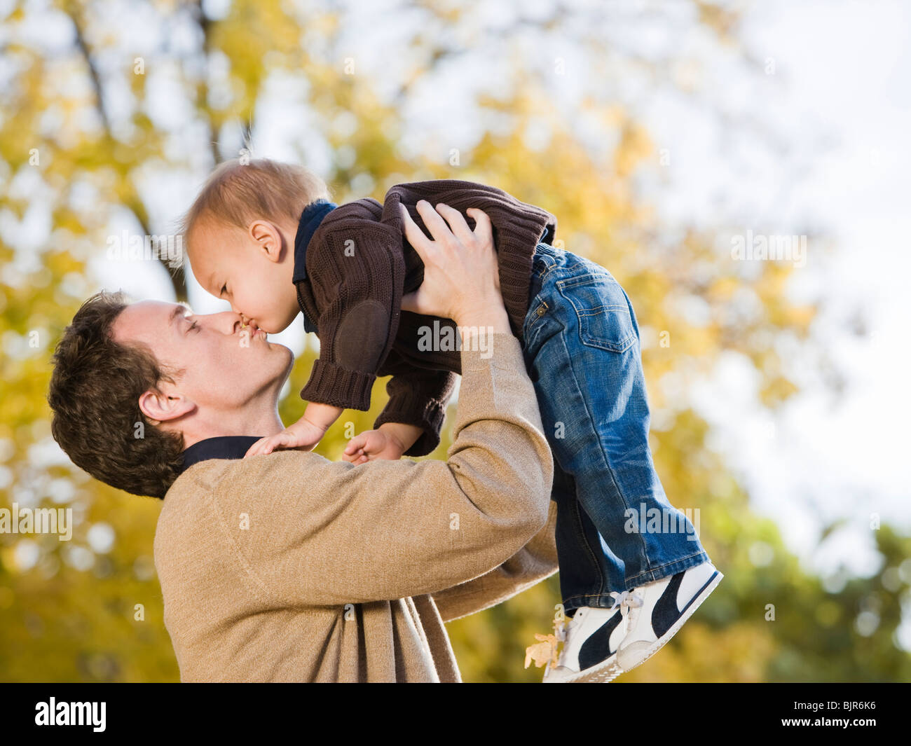 dad lifting baby boy in the air Stock Photo - Alamy