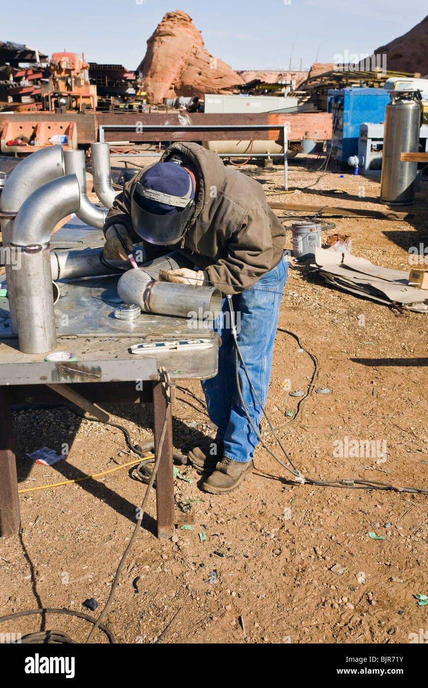 Man TIG welding pipes, outdoor setting Stock Photo - Alamy