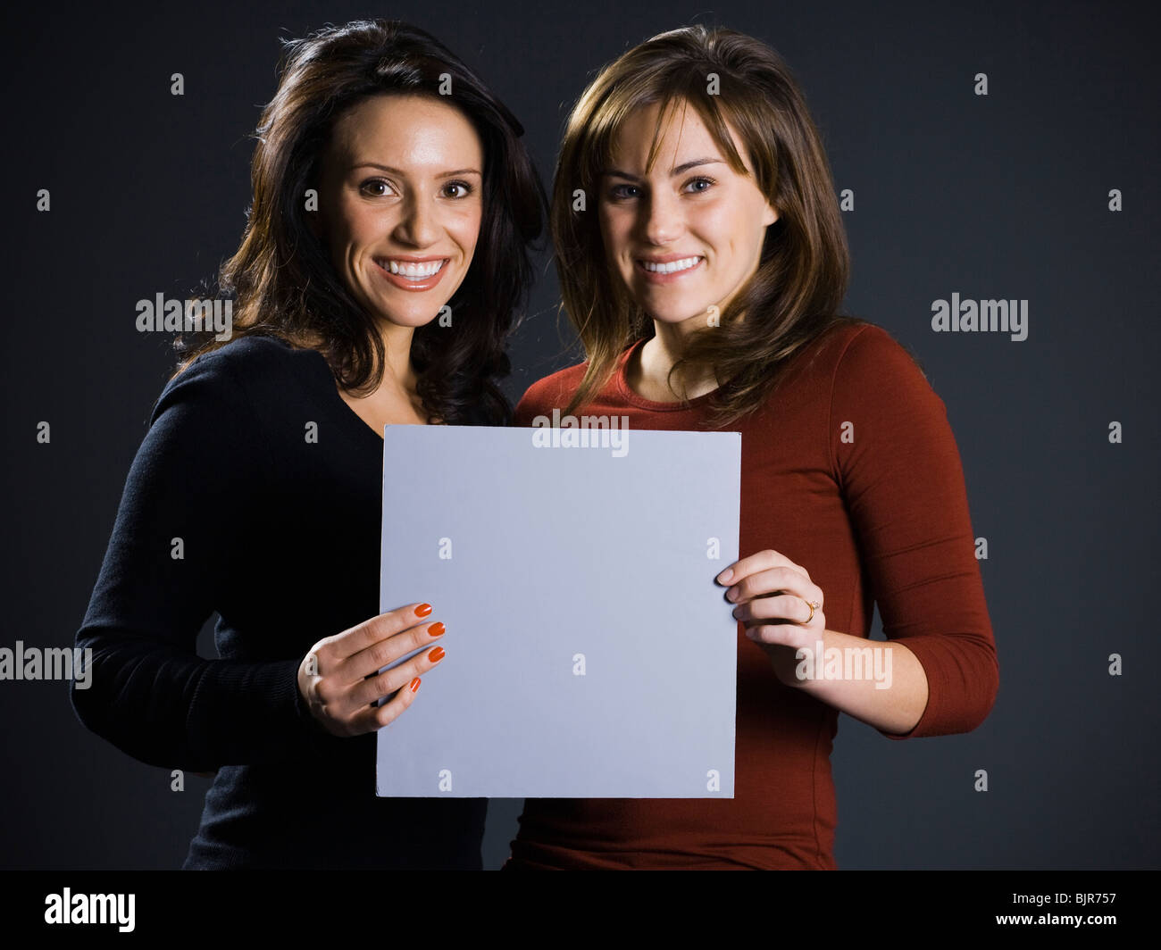two women holding a sign Stock Photo - Alamy