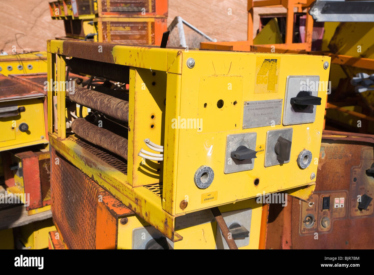 Old yellow welding machine stacked at a scrap metal junk yard Stock ...