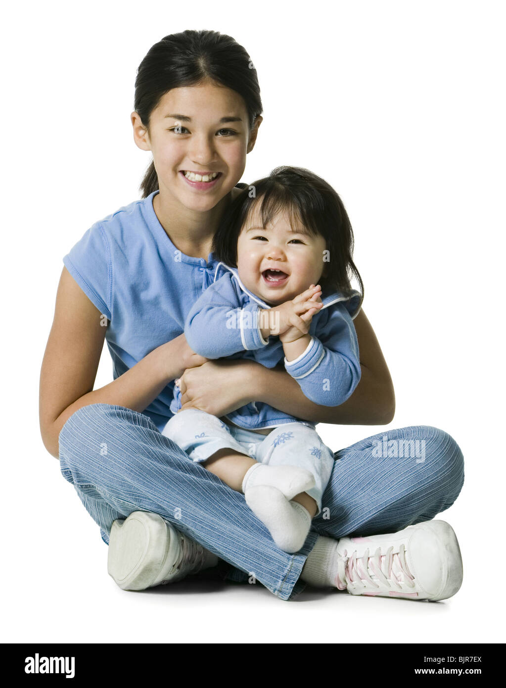 Girl holding child Stock Photo - Alamy