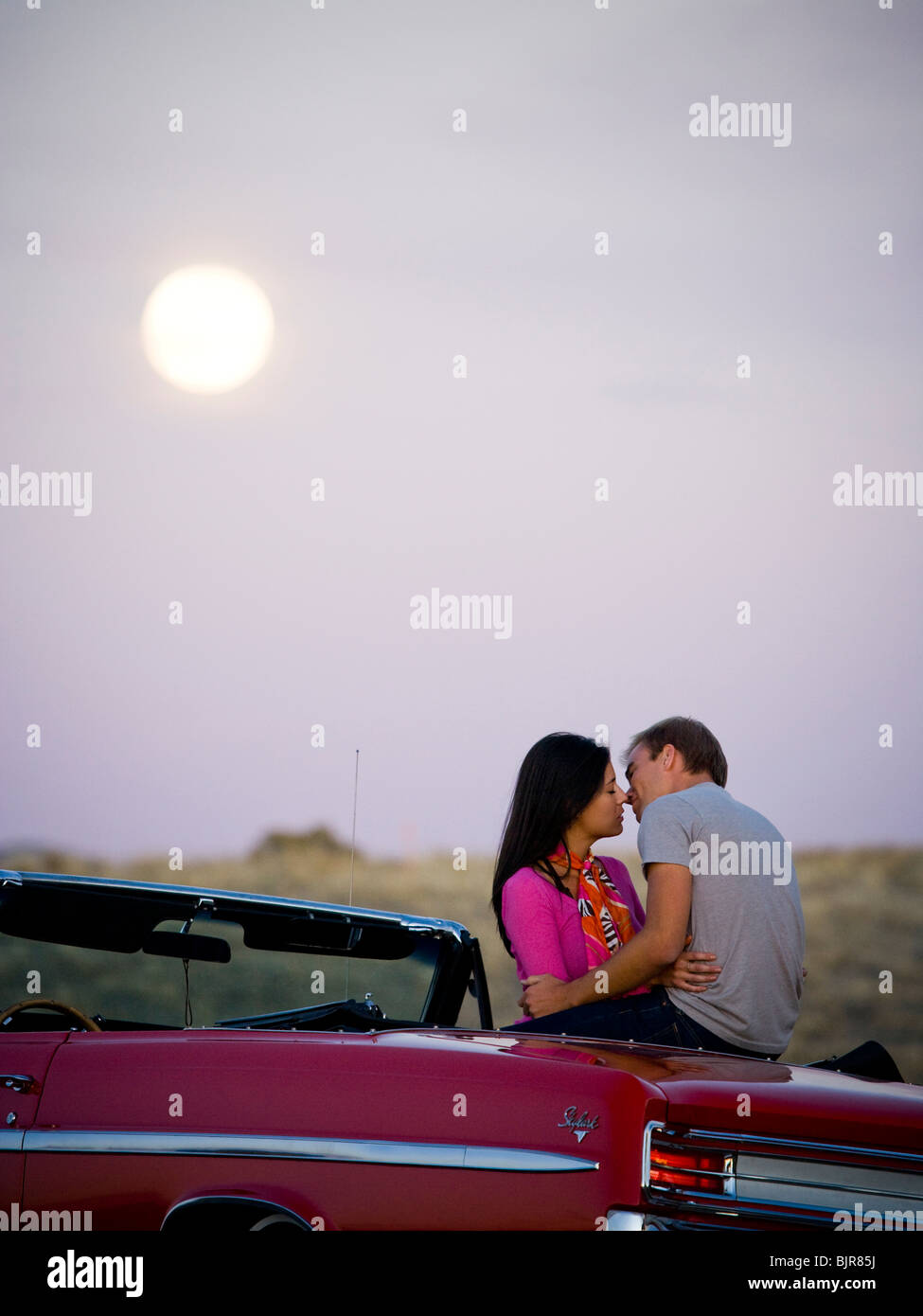 couple under a full moon Stock Photo - Alamy
