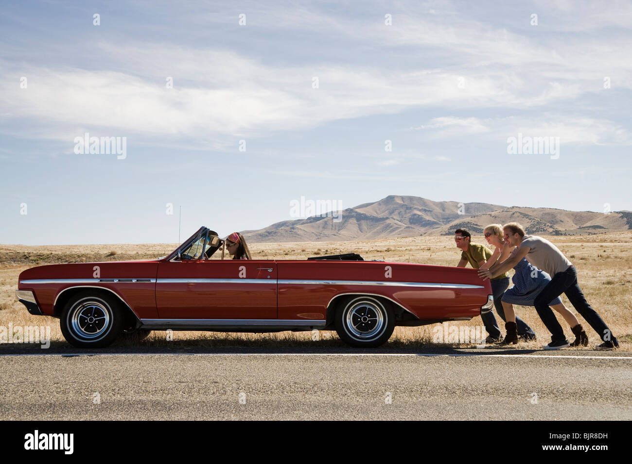 People Pushing A Car