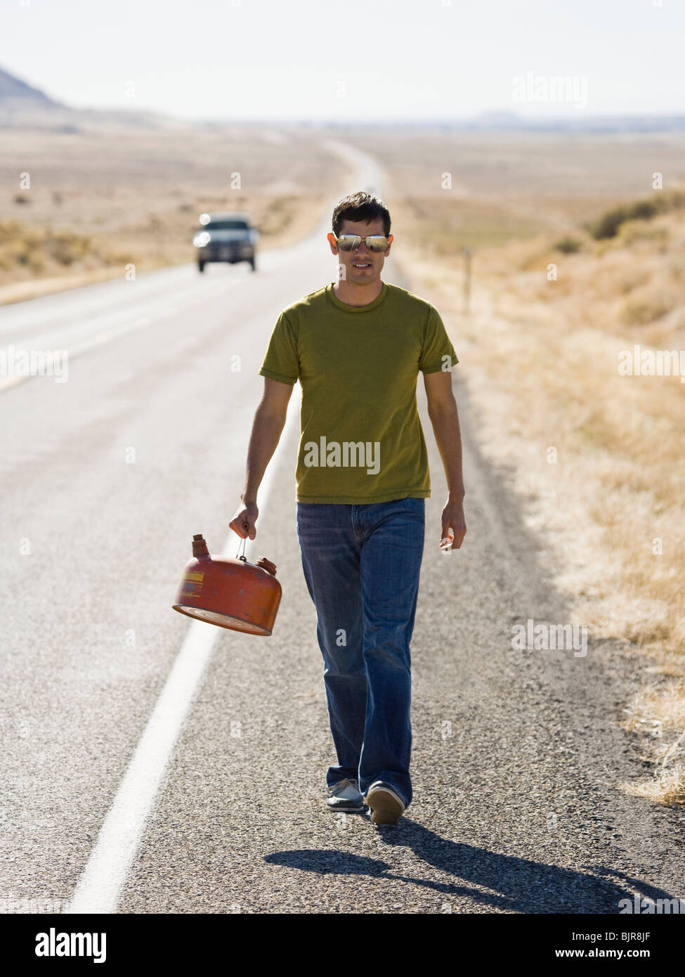 man walking with a gas can Stock Photo - Alamy