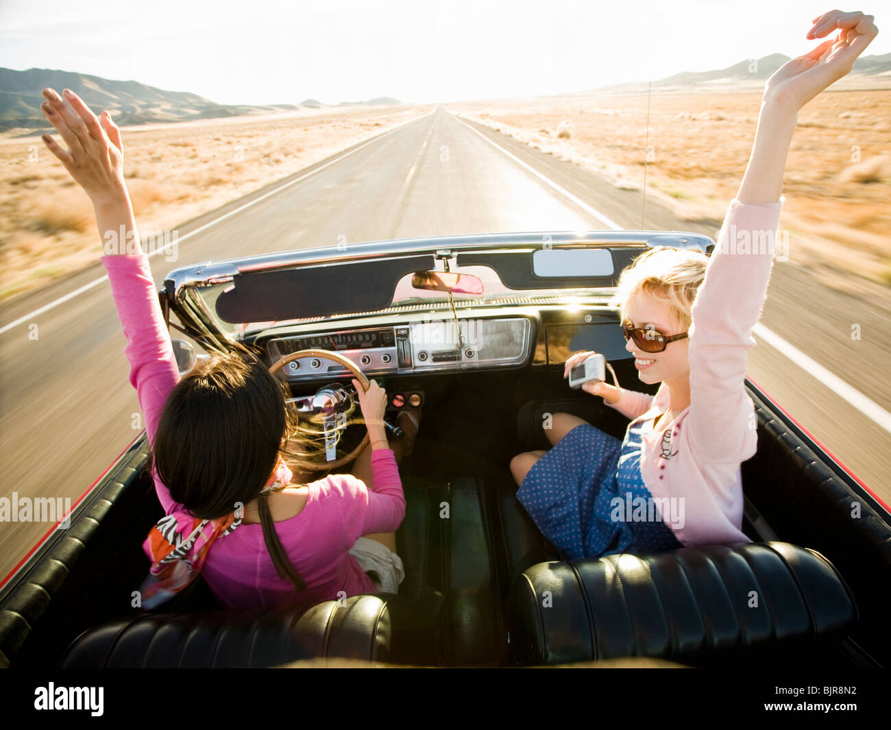 two women in a red convertible Stock Photo - Alamy