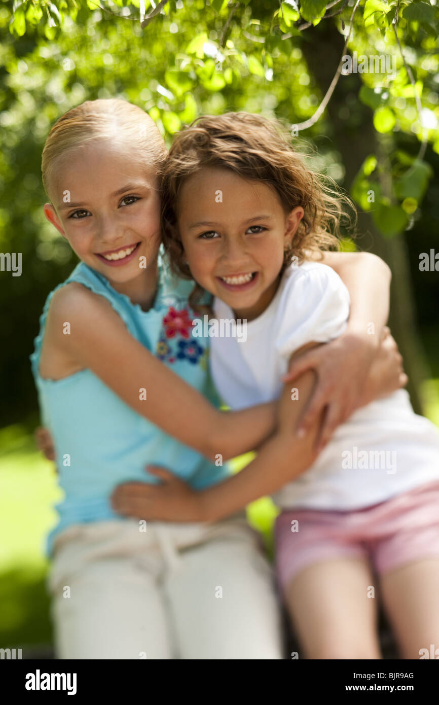 Three children arm in arm Stock Photo - Alamy