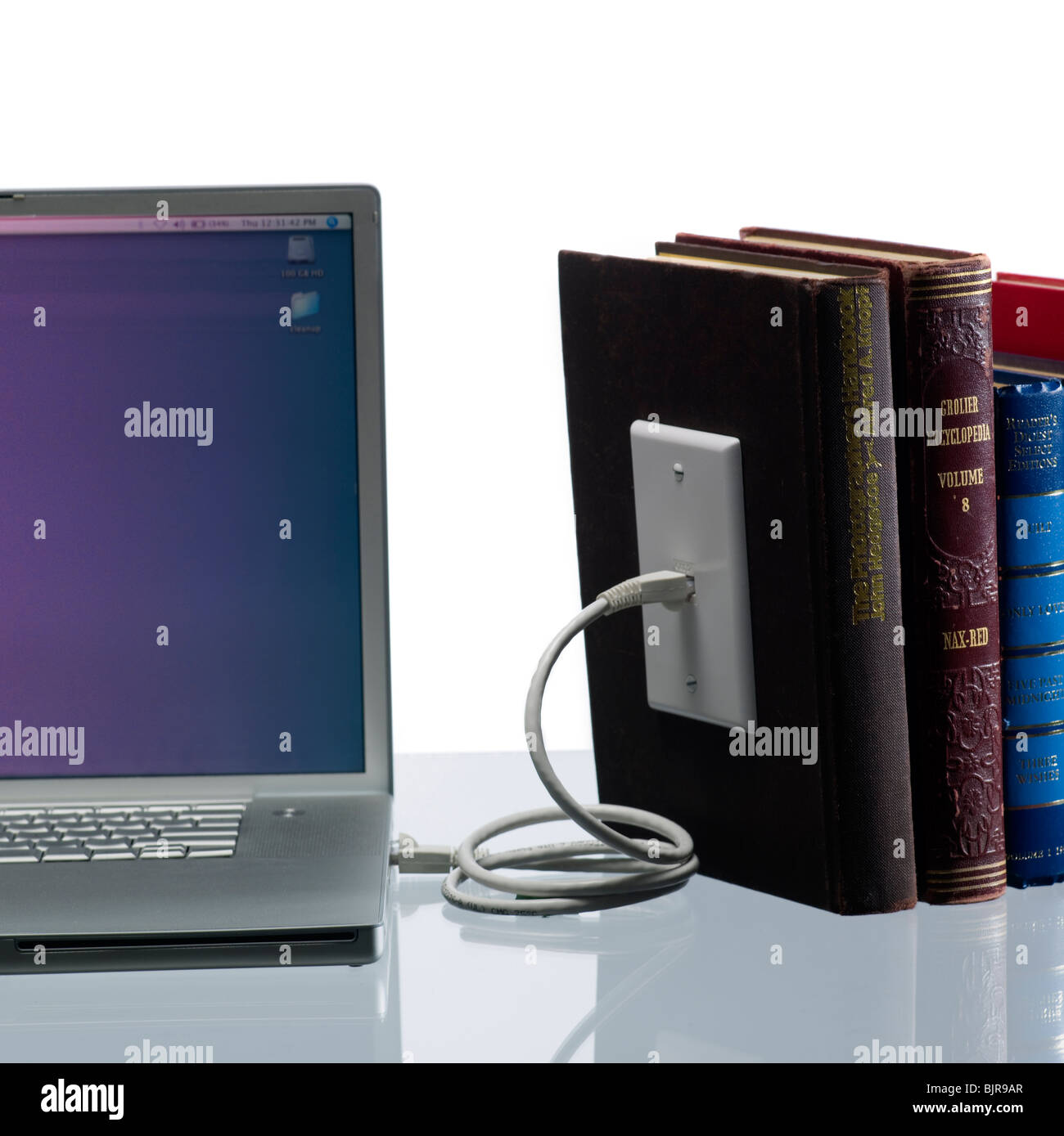 notebook computer plugged into books Stock Photo - Alamy