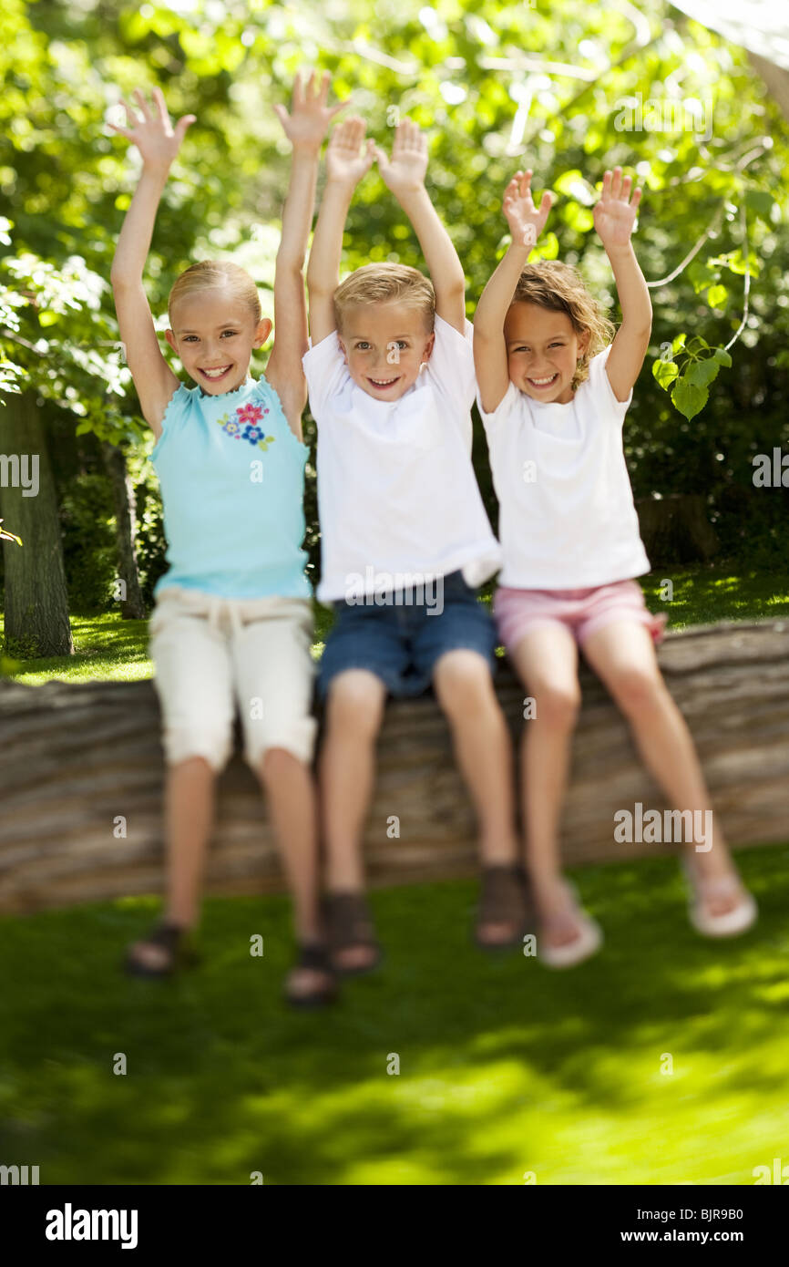 Three children arm in arm Stock Photo - Alamy