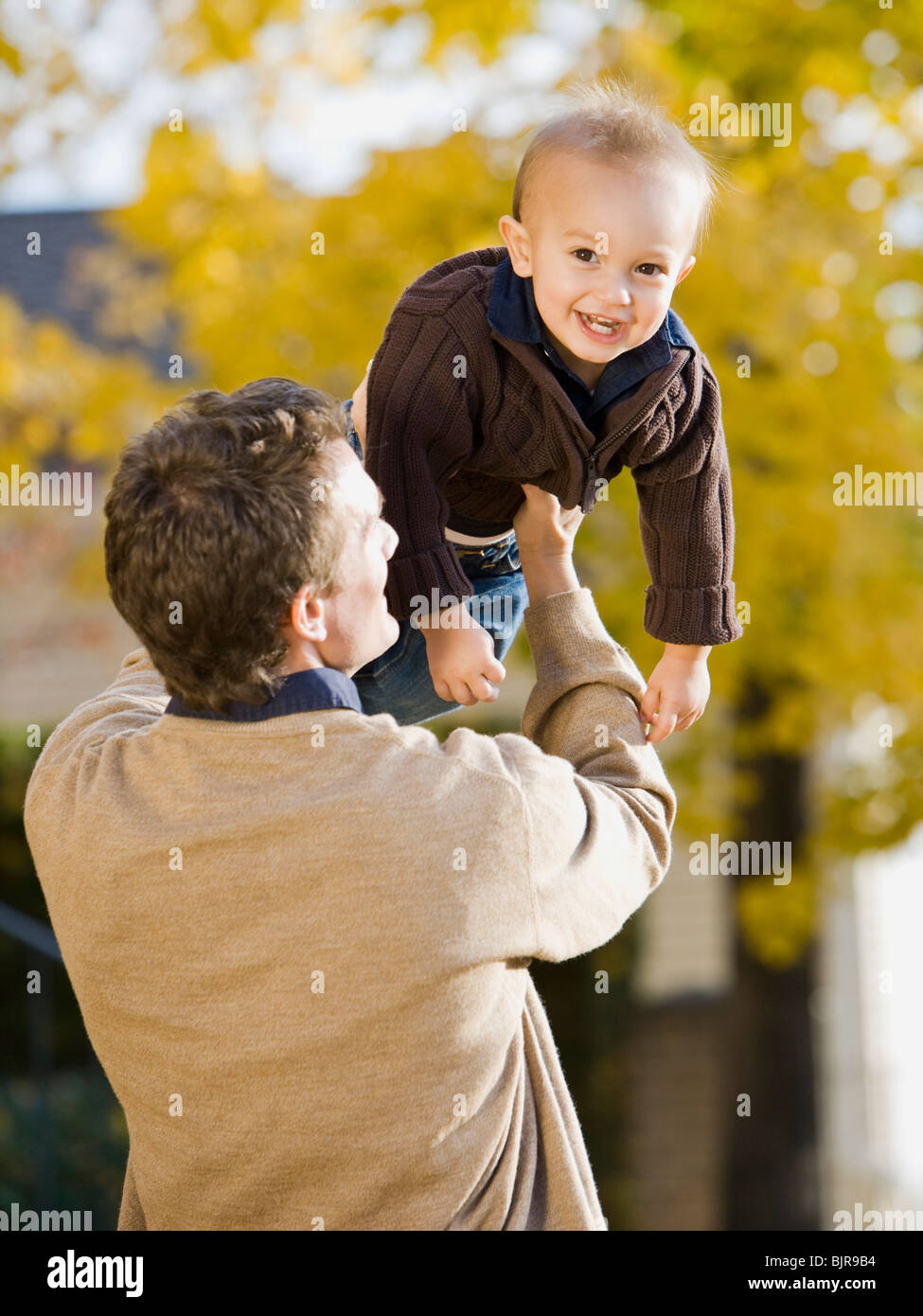 dad lifting baby boy in the air Stock Photo - Alamy