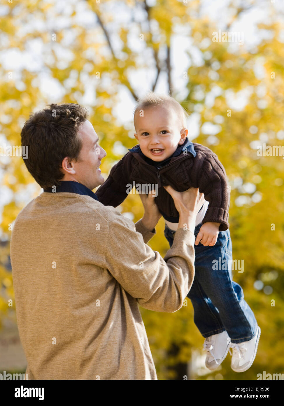 dad lifting baby boy in the air Stock Photo - Alamy