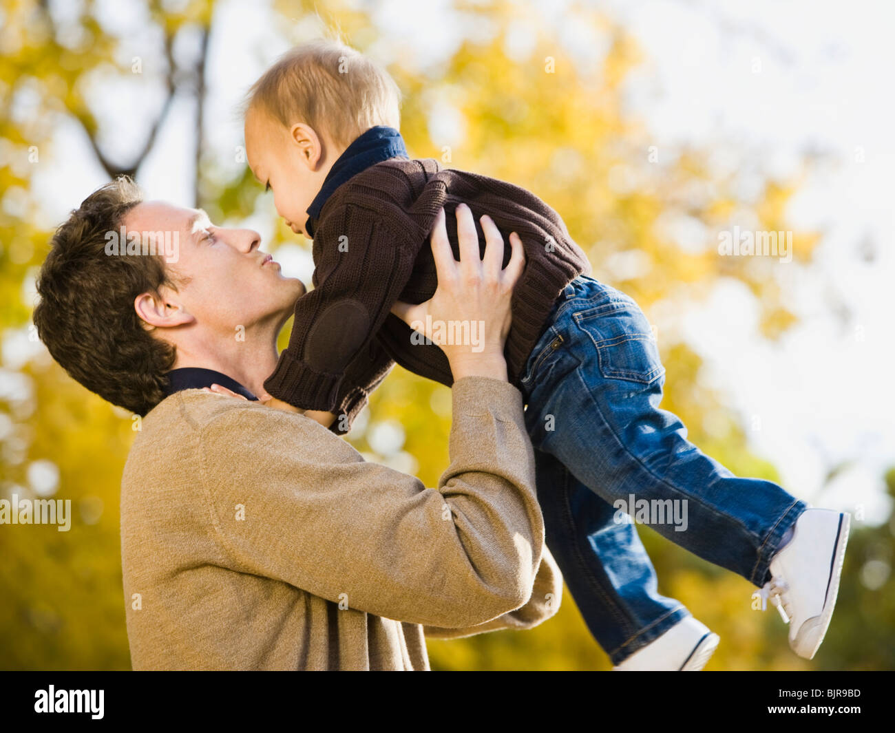 dad lifting baby boy in the air Stock Photo - Alamy