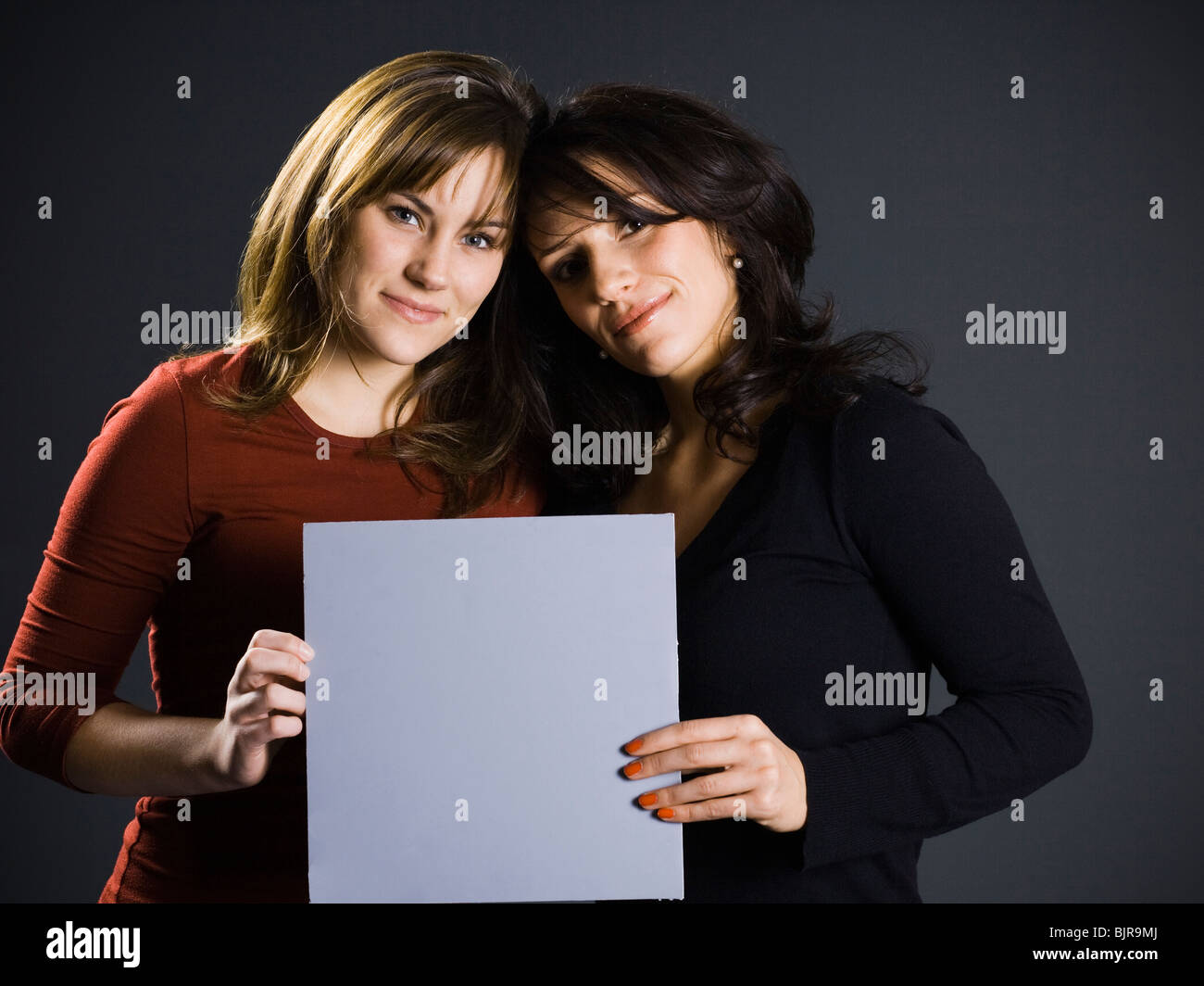two women holding a sign Stock Photo - Alamy