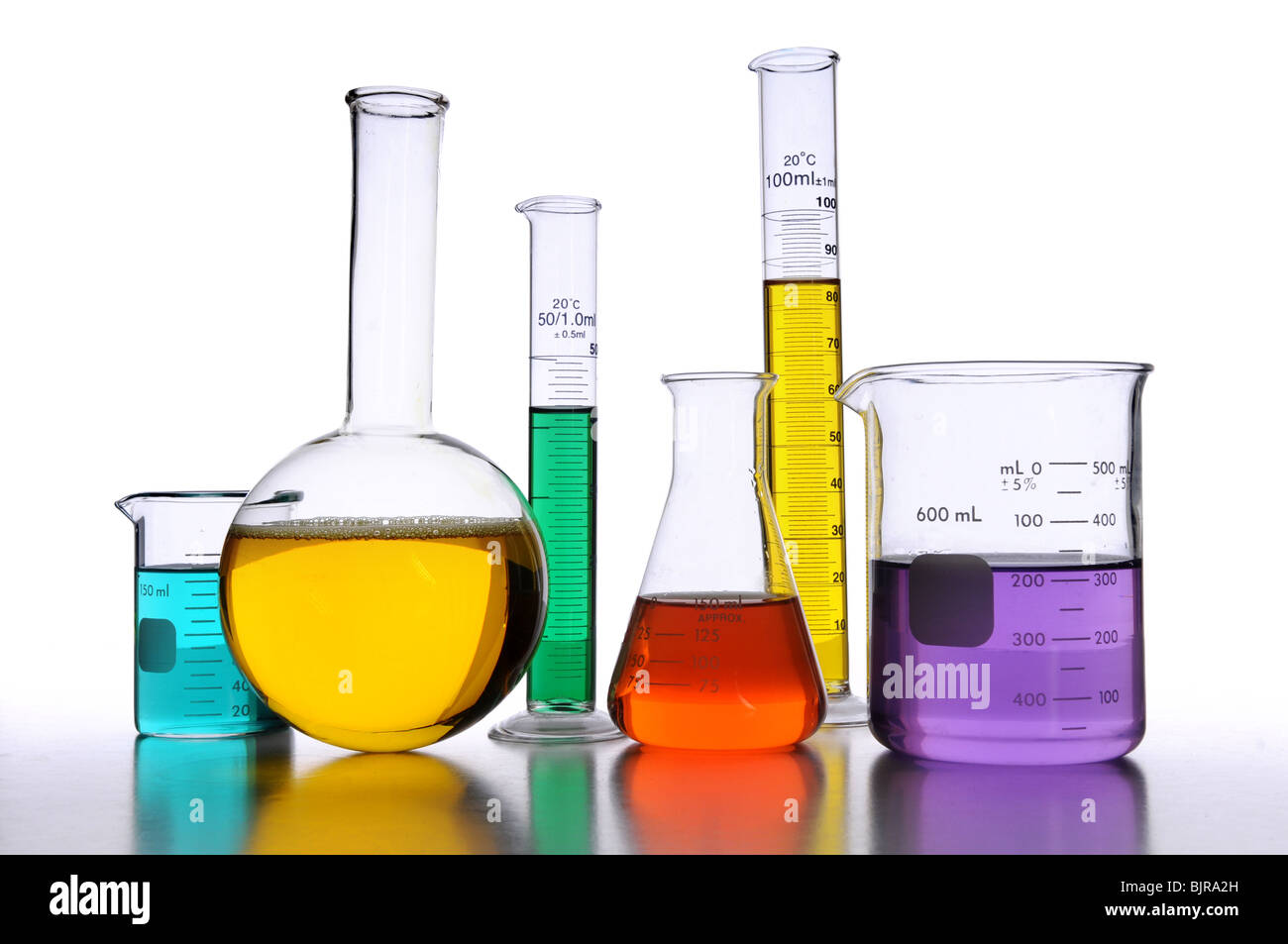 Laboratory glassware with liquids of different colors over white ...
