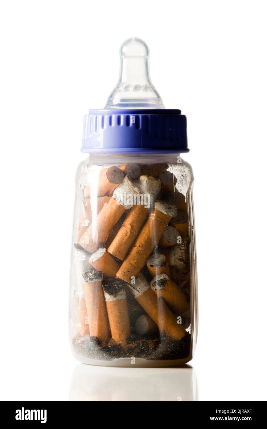 Cigarettes in baby bottle on white background Stock Photo - Alamy