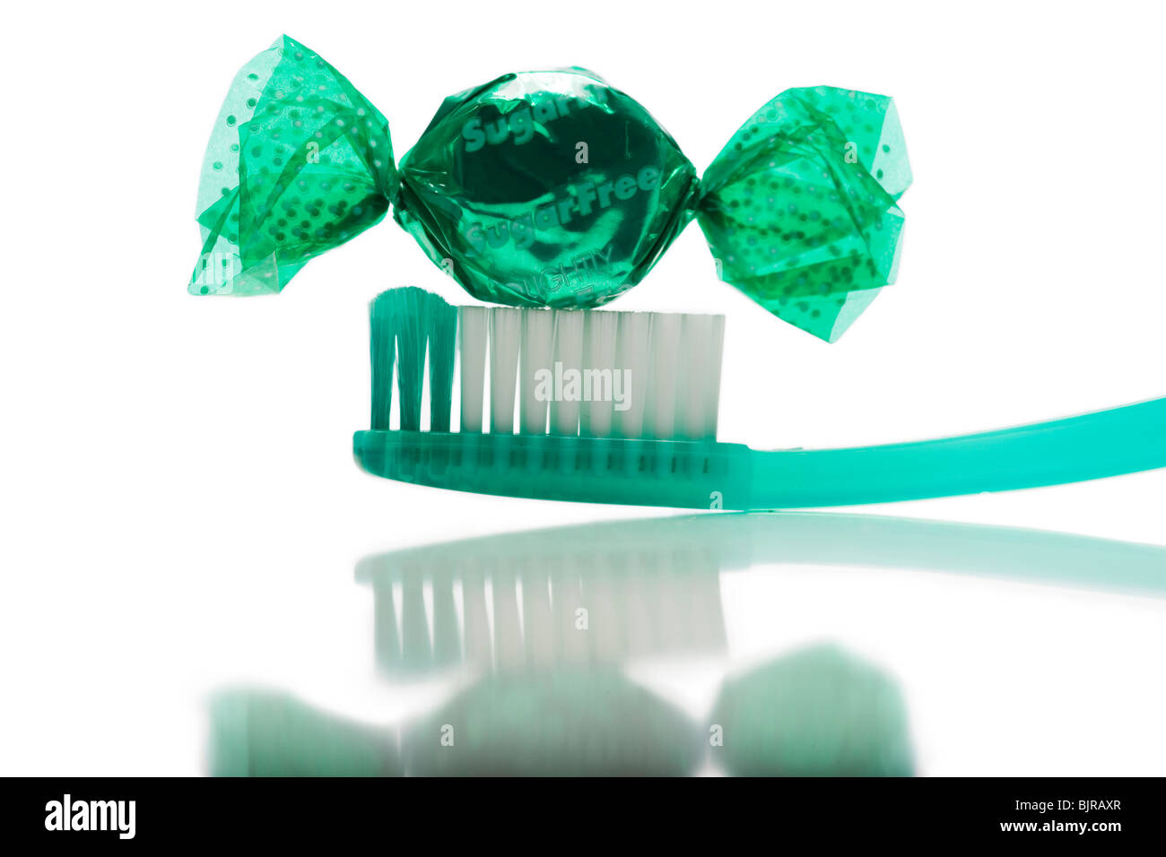 Candy with toothbrush on white background Stock Photo - Alamy