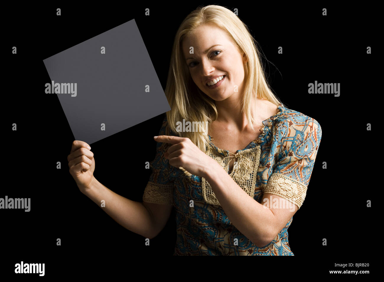 Smiling woman posing with back to the camera Stock Photo - Alamy