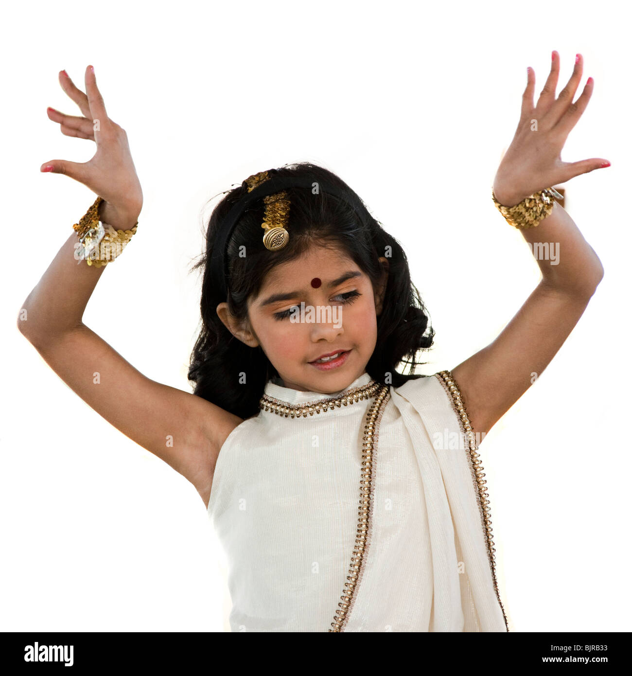 Girl (8-9) wearing traditional sari performing figures from indian ...