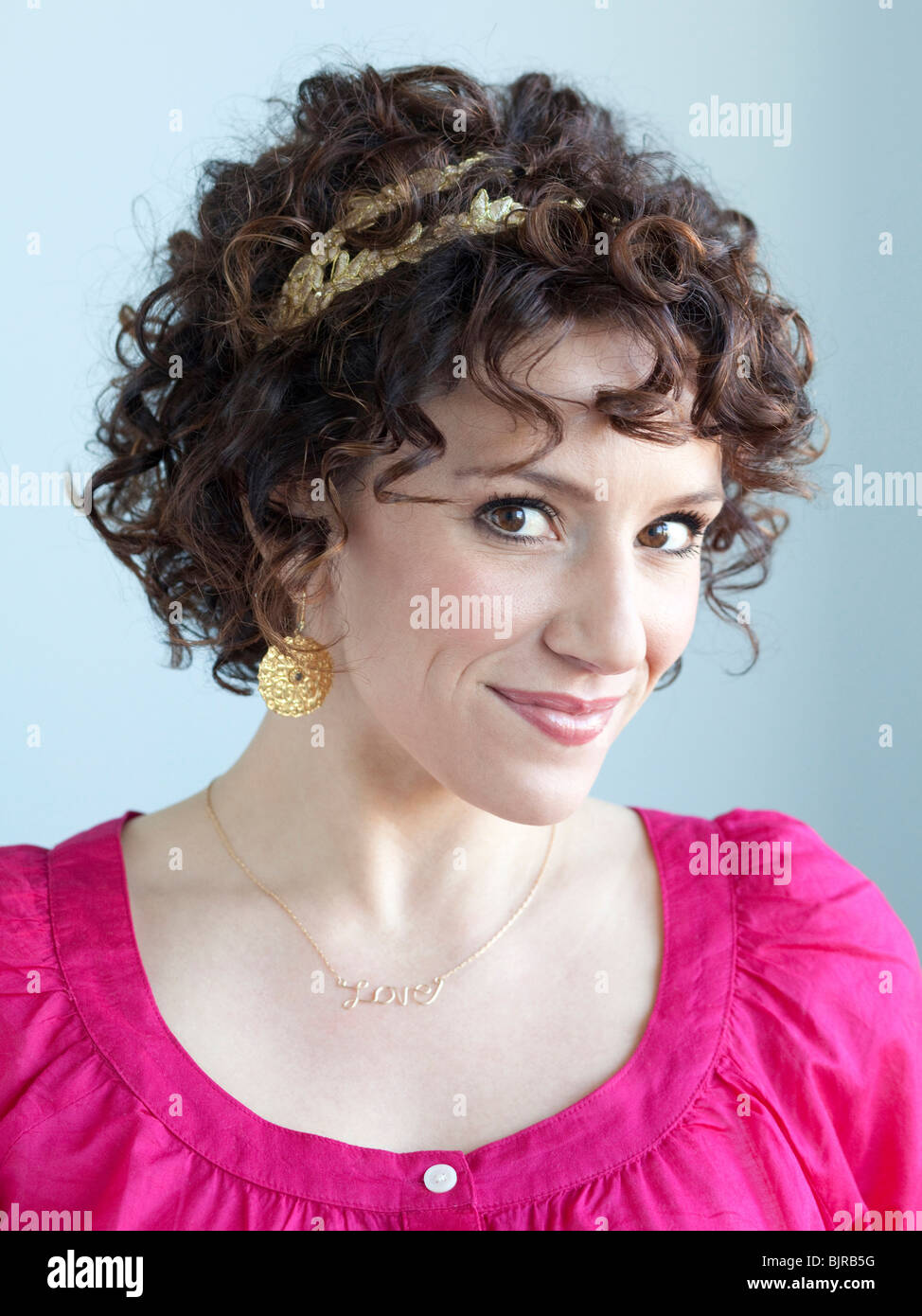 Young woman smiling, portrait, studio shot Stock Photo - Alamy