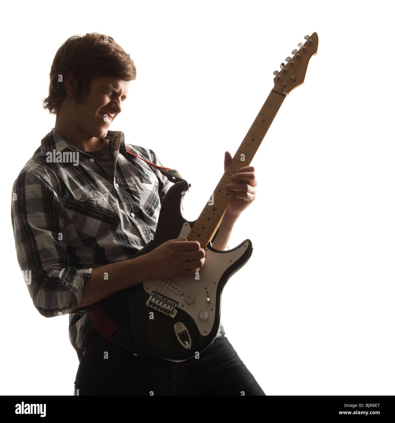 Young man playing electric guitar, studio shot Stock Photo - Alamy