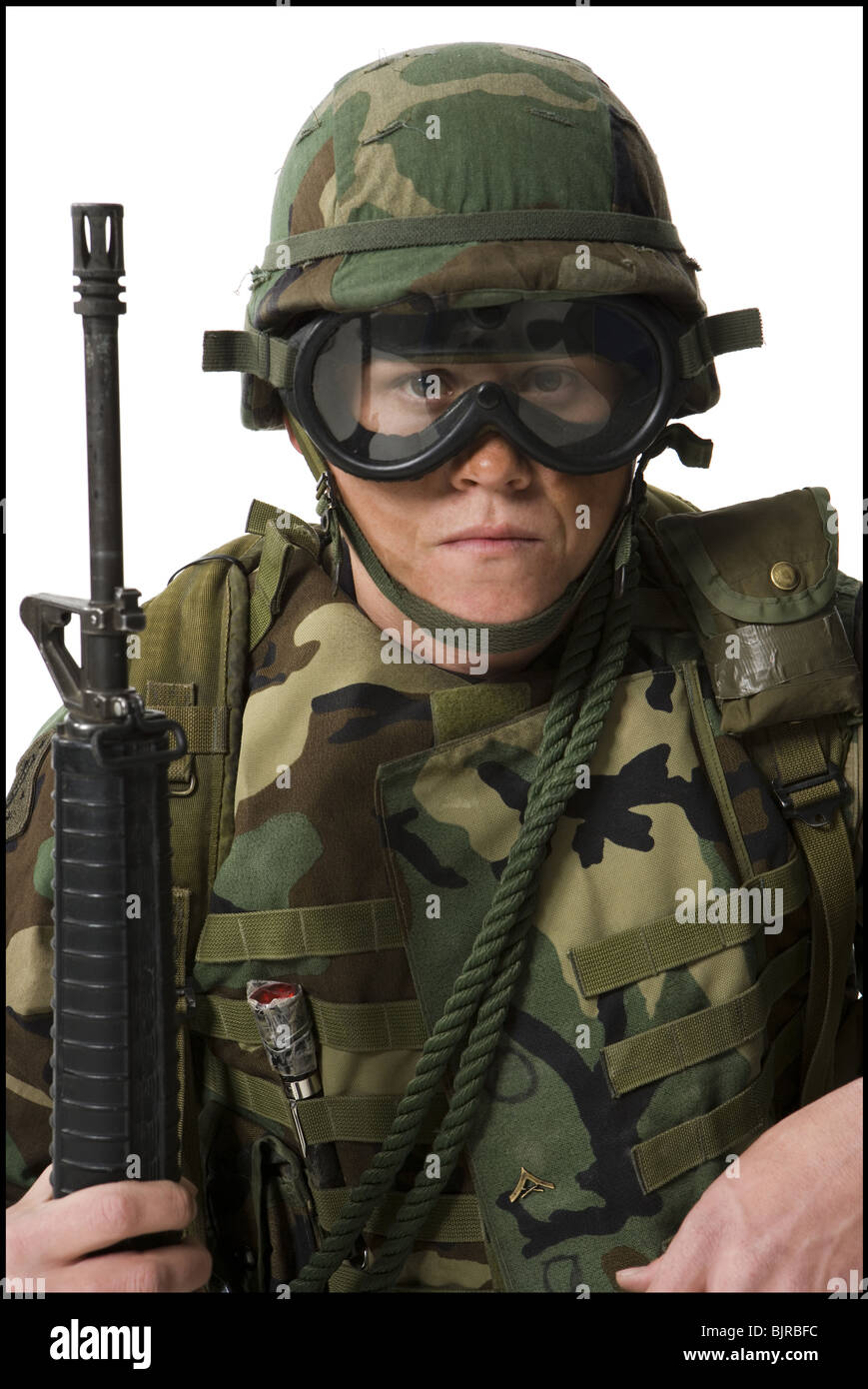 Soldier posing with weapon Stock Photo - Alamy