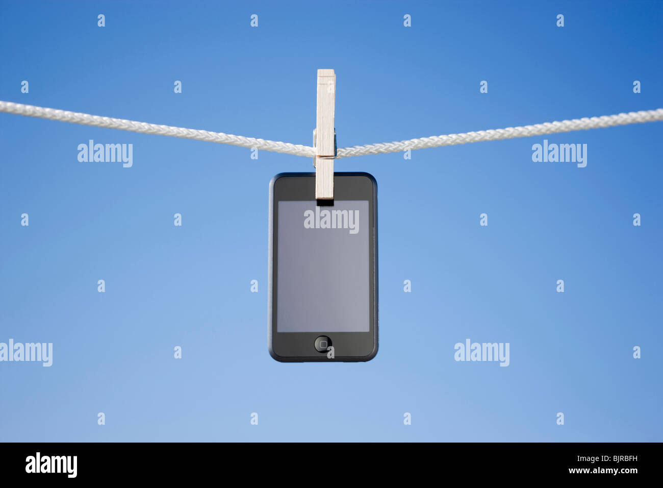 MP3 player hanging on washing line Stock Photo - Alamy