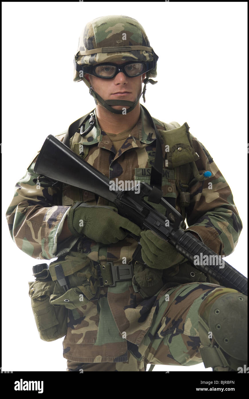 Soldier posing with weapon Stock Photo - Alamy