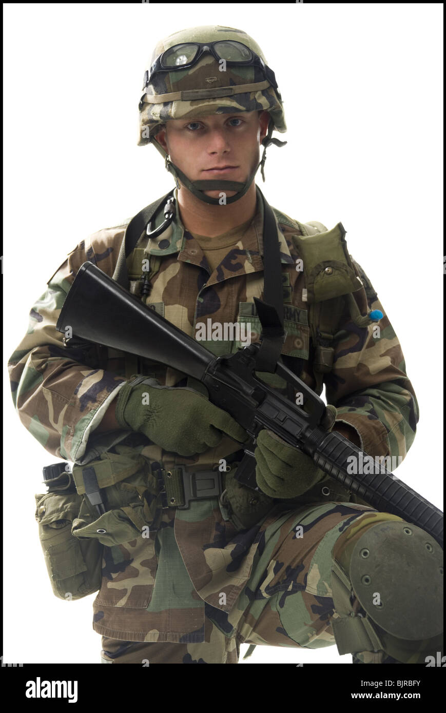 Soldier posing with weapon Stock Photo - Alamy